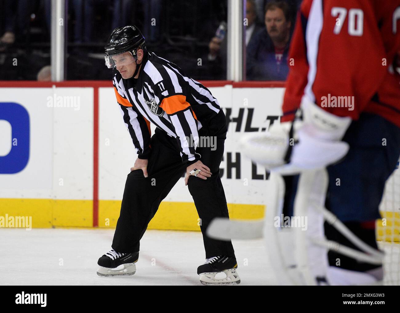 NHL referee Kelly Sutherland (11) looks on during the first period of ...