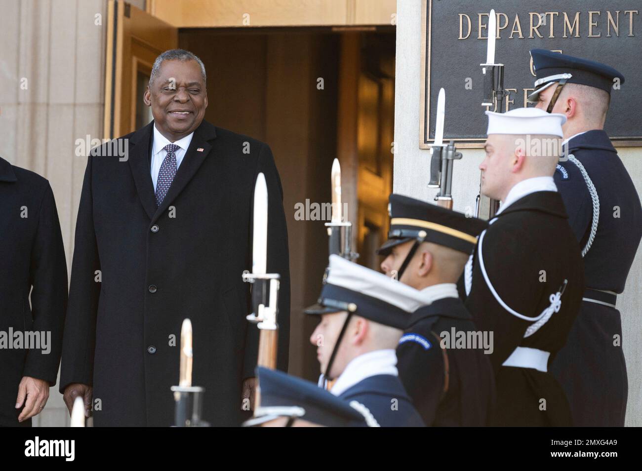 Secretary of Defense Lloyd Austin looks toward the honor guard during ...