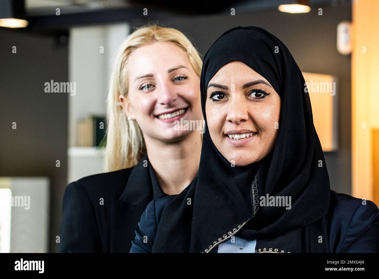 Smiling business women with different ethnicities and cultures looking ...
