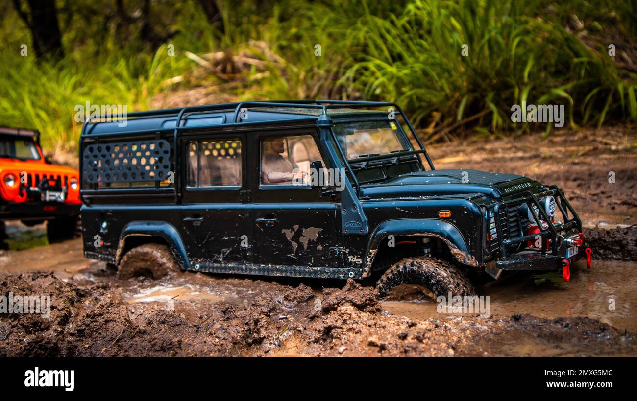 A closeup of small figure-toys of cars with remote control stuck in the ...