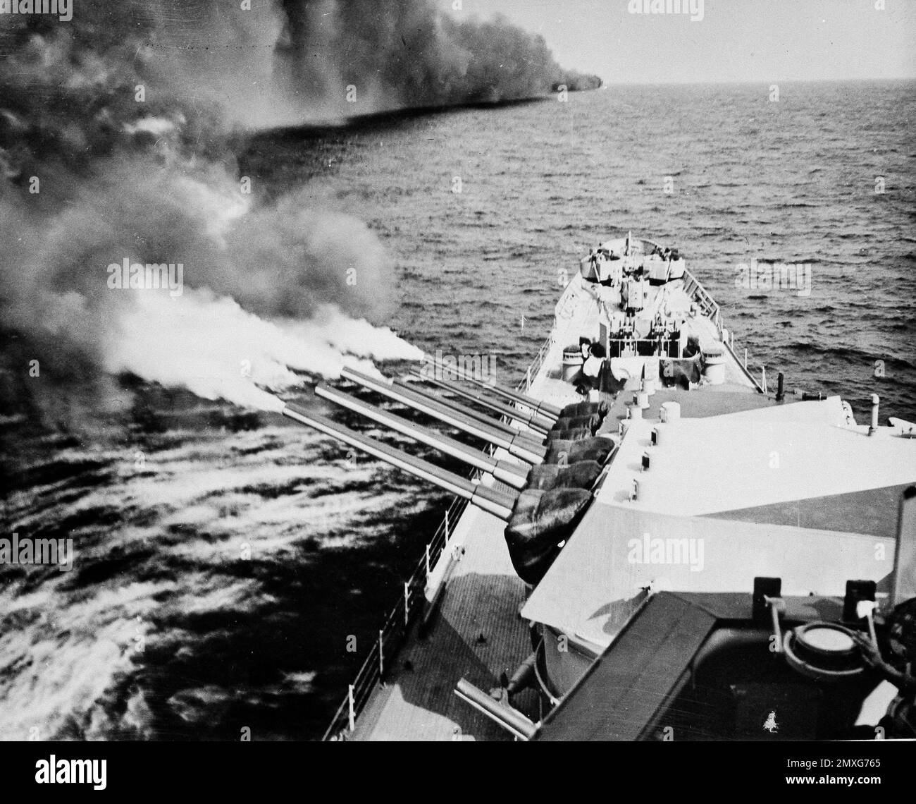 In this photo provided by the U.S. Navy, big guns of the USS Quincy ...