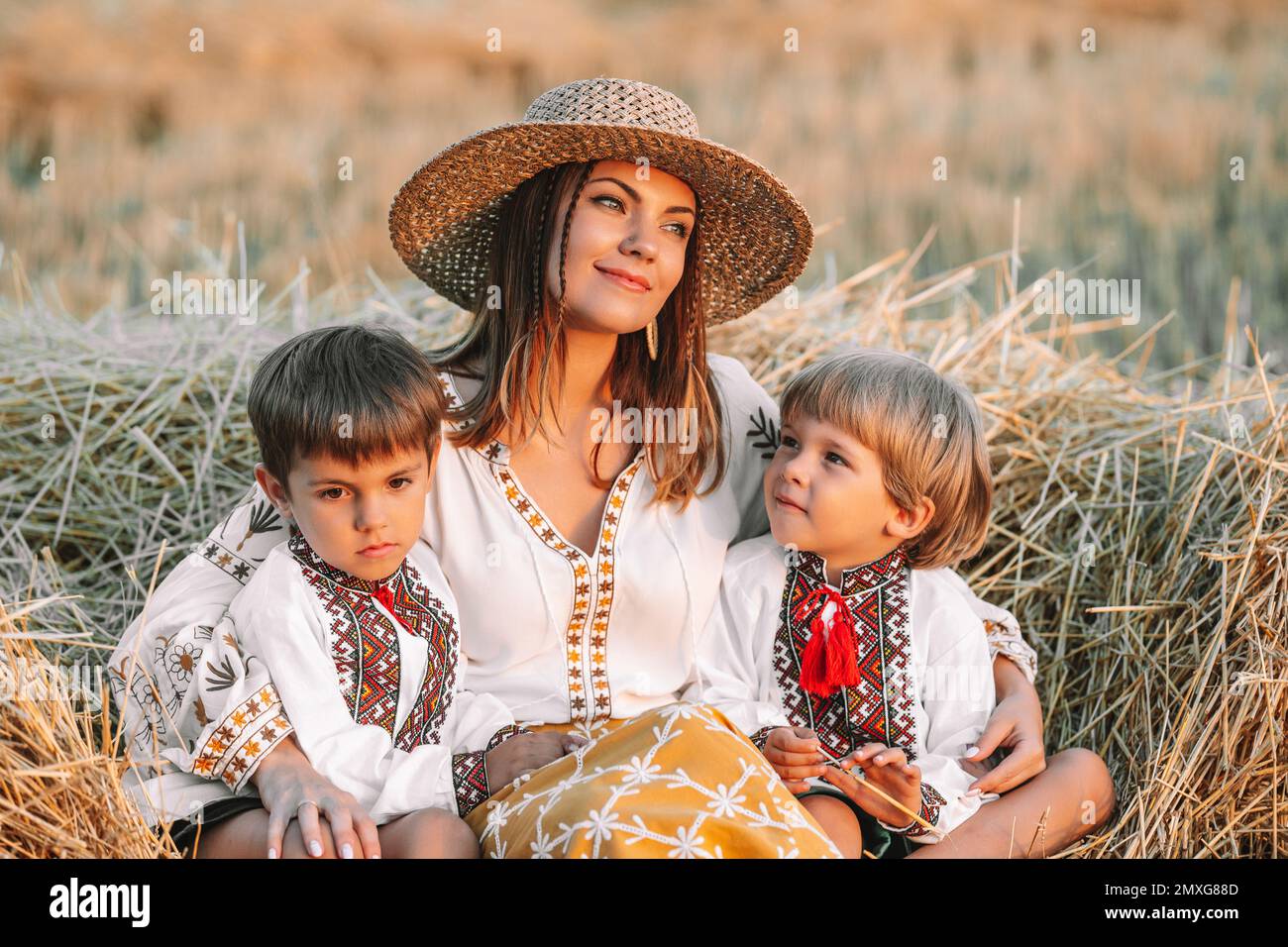 Beautiful ukrainian family - woman sons in vyshyvanka shirts on hay ...