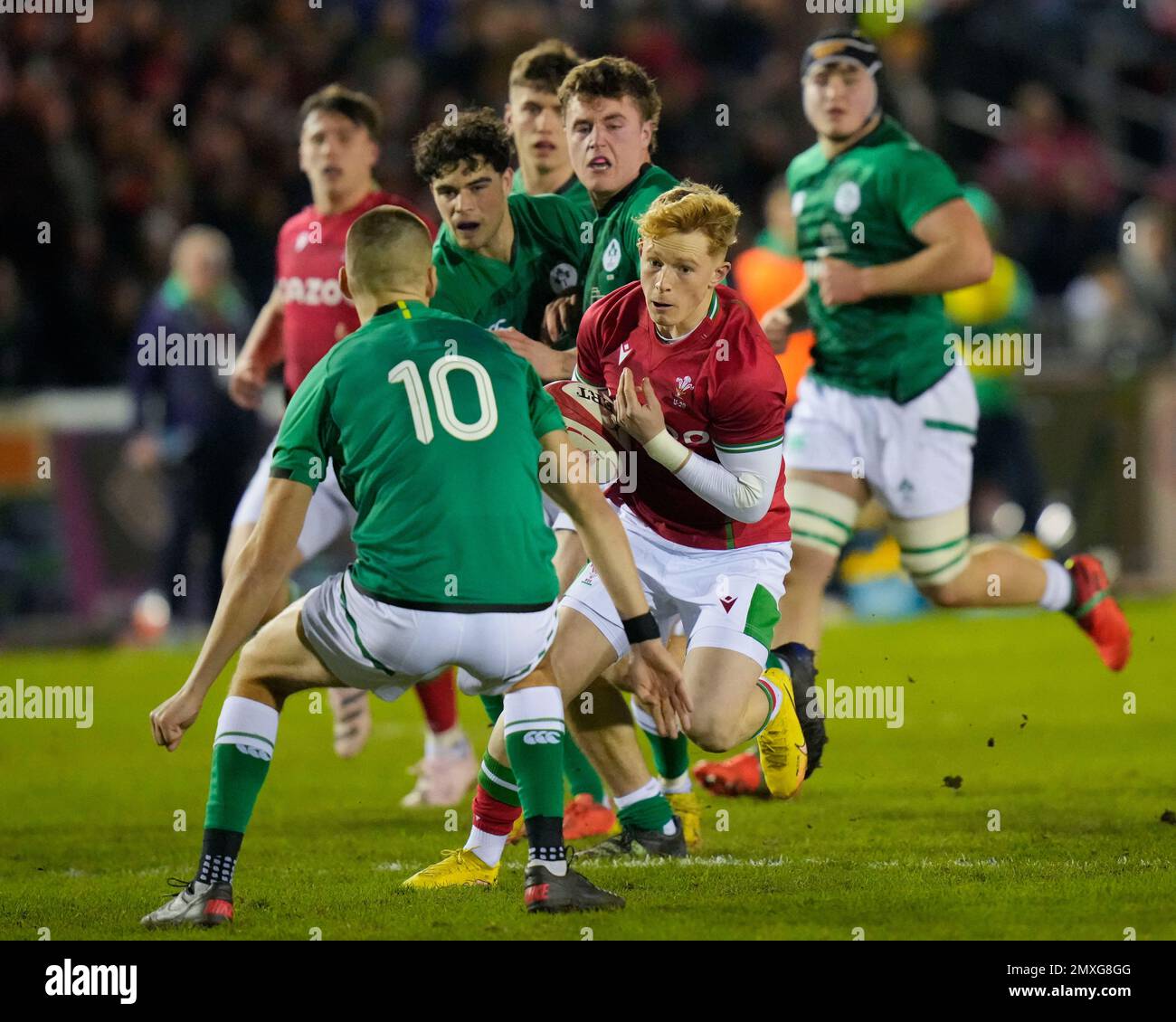 Harri Houston #11 of Wales runs at Sam Prendagast #10 of Ireland U20's ...