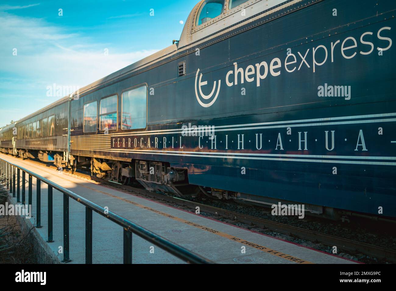 The Chepe Express Train on the railway of Mexico against the sunny blue ...