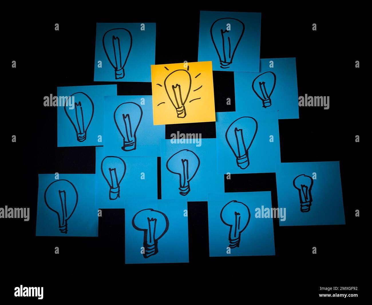 Concept of lighbulbs with an illuminated lightbulb to indicate ...