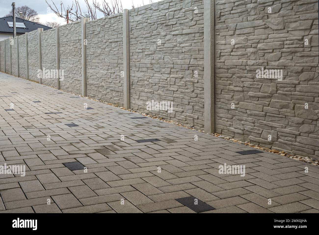 Concrete pattern fence and block paving tiles Stock Photo - Alamy