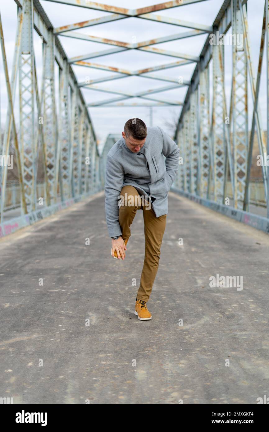 A vertical shot of a of a Caucasian white man shaking off the dust off ...