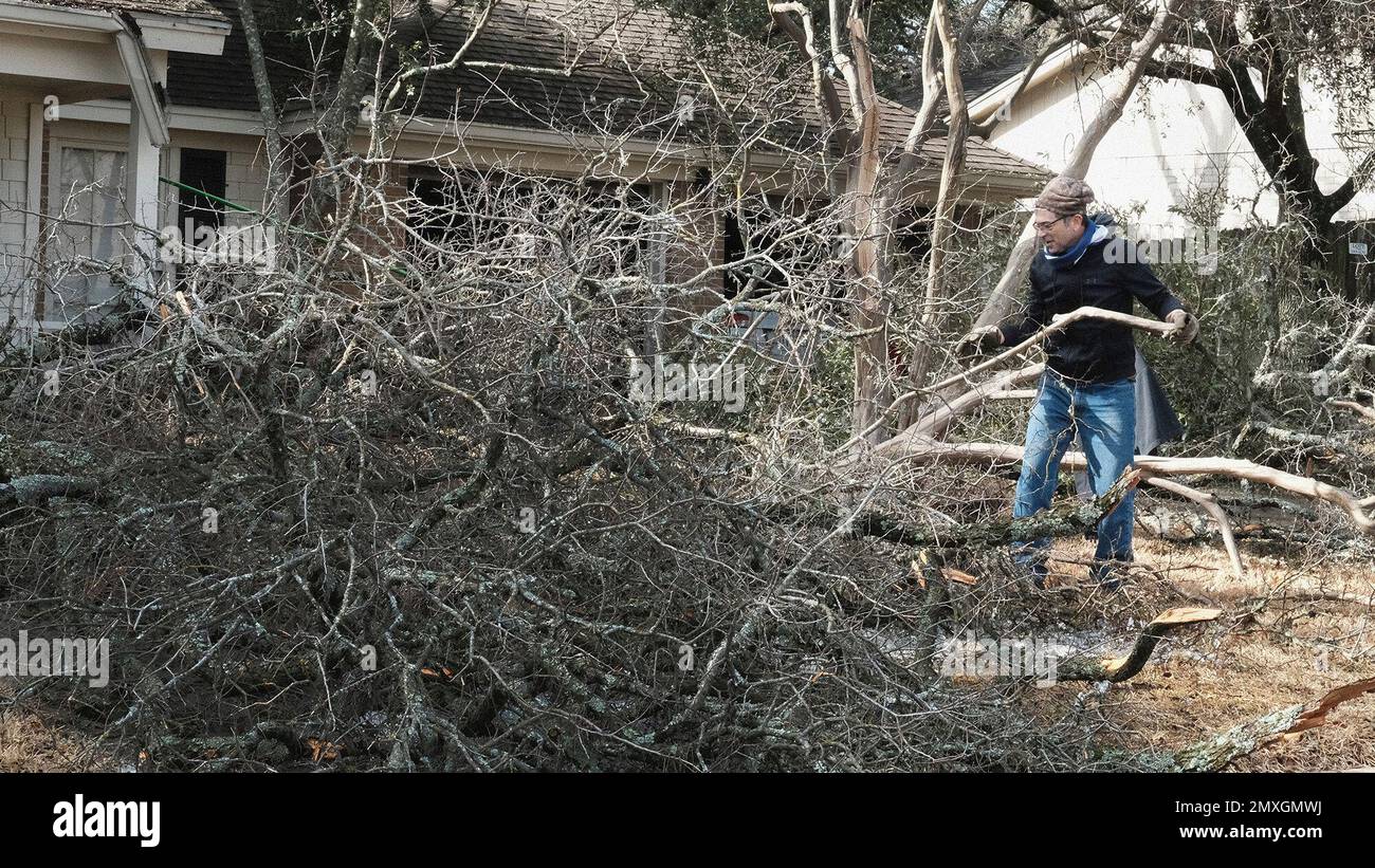 Steve Spencer cleans up limbs from his yard in northwest Austin, Texas ...