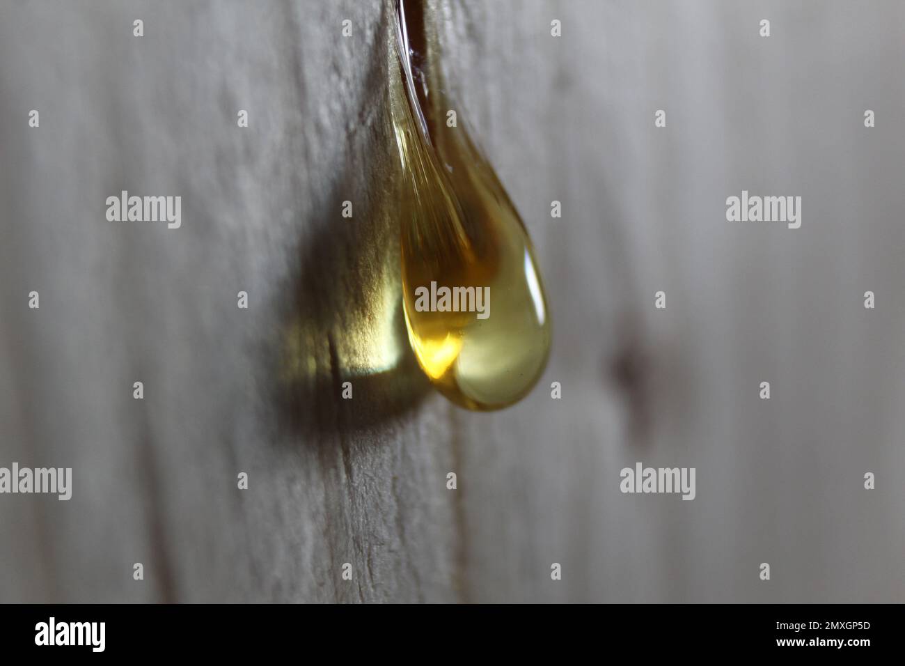 a drip of resin drips down the pine board. fresh board building ...