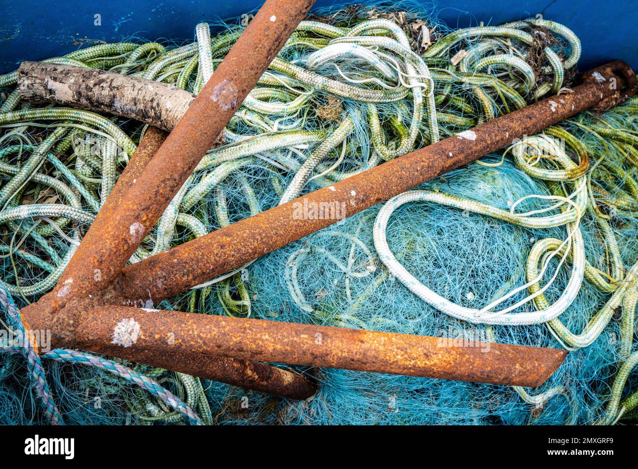 Fishing nets and rusting anchor - colourful abstract, concept ...