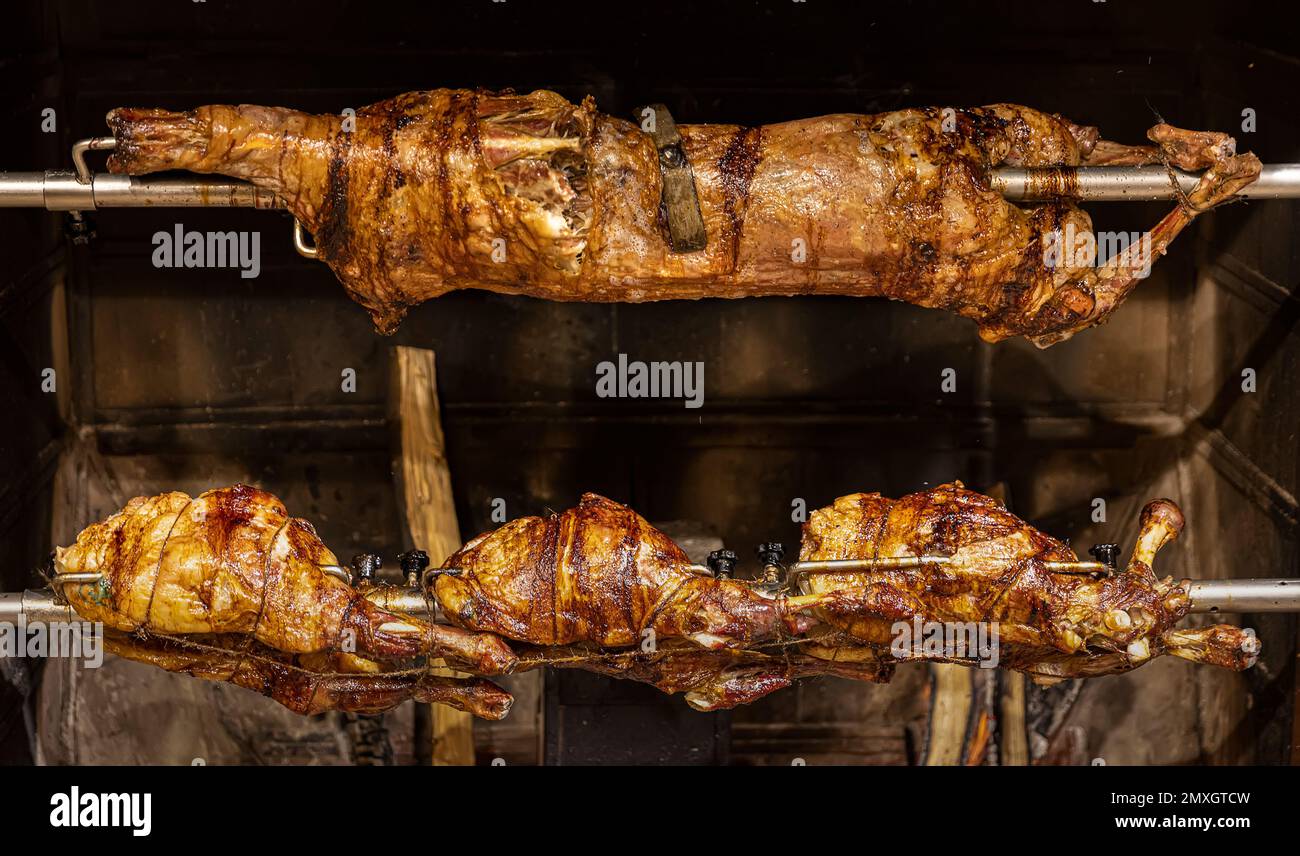 Lamb on grilled skewers using hot charcoal. The lamb is cooked entirely ...