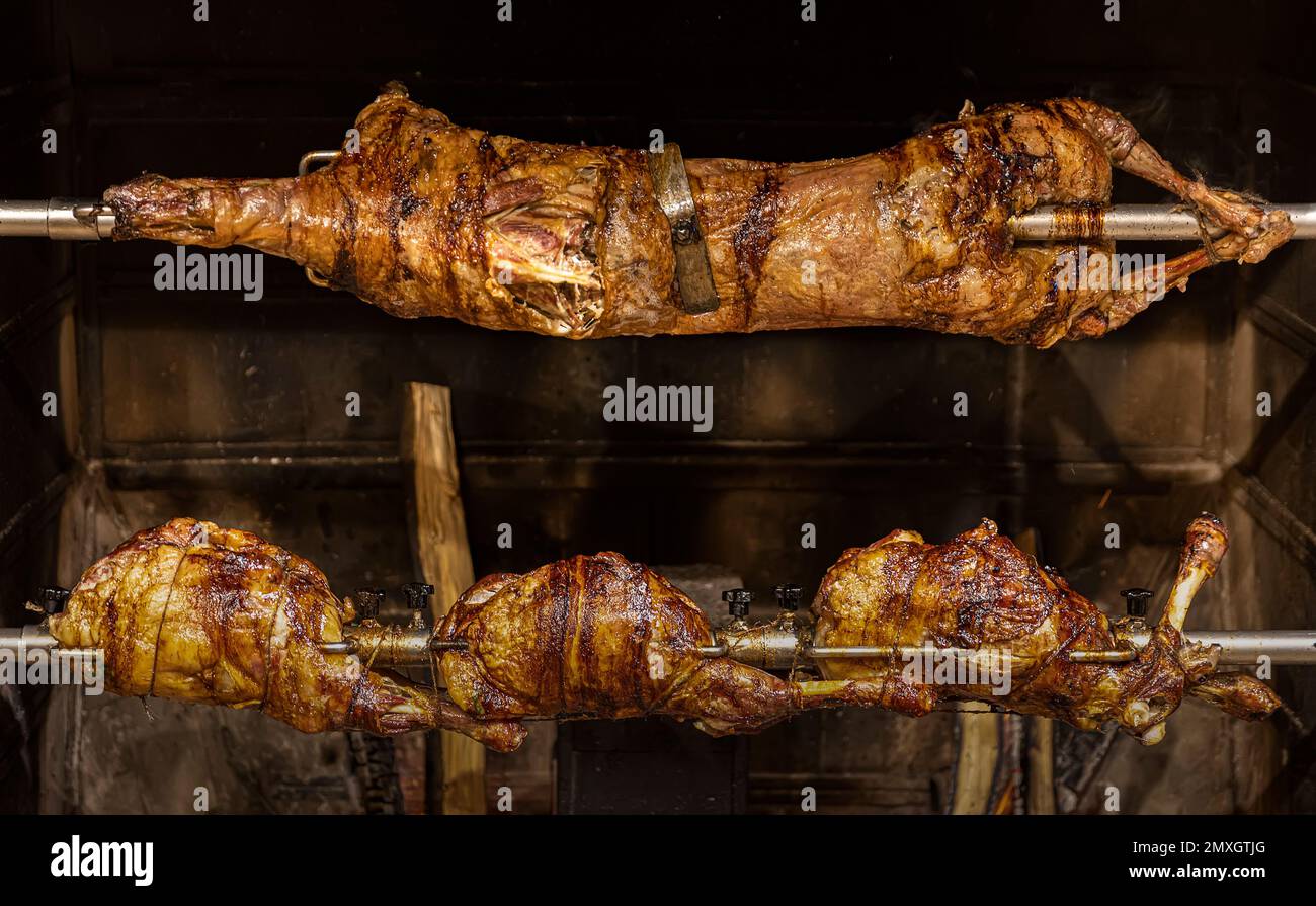 Lamb on grilled skewers using hot charcoal. The lamb is cooked entirely ...