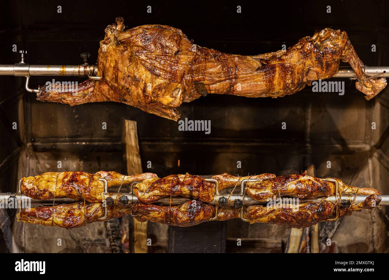 Lamb on grilled skewers using hot charcoal. The lamb is cooked entirely ...