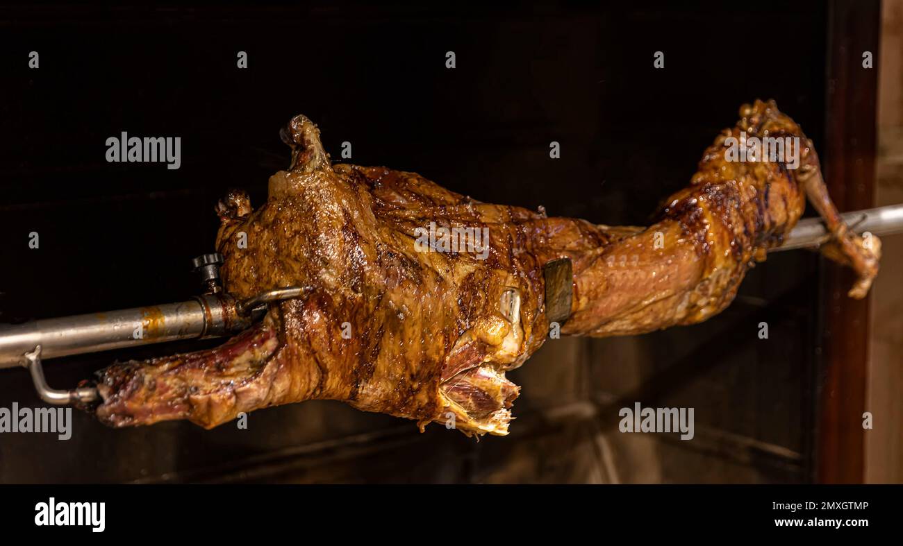 Lamb on grilled skewers using hot charcoal. The lamb is cooked entirely ...