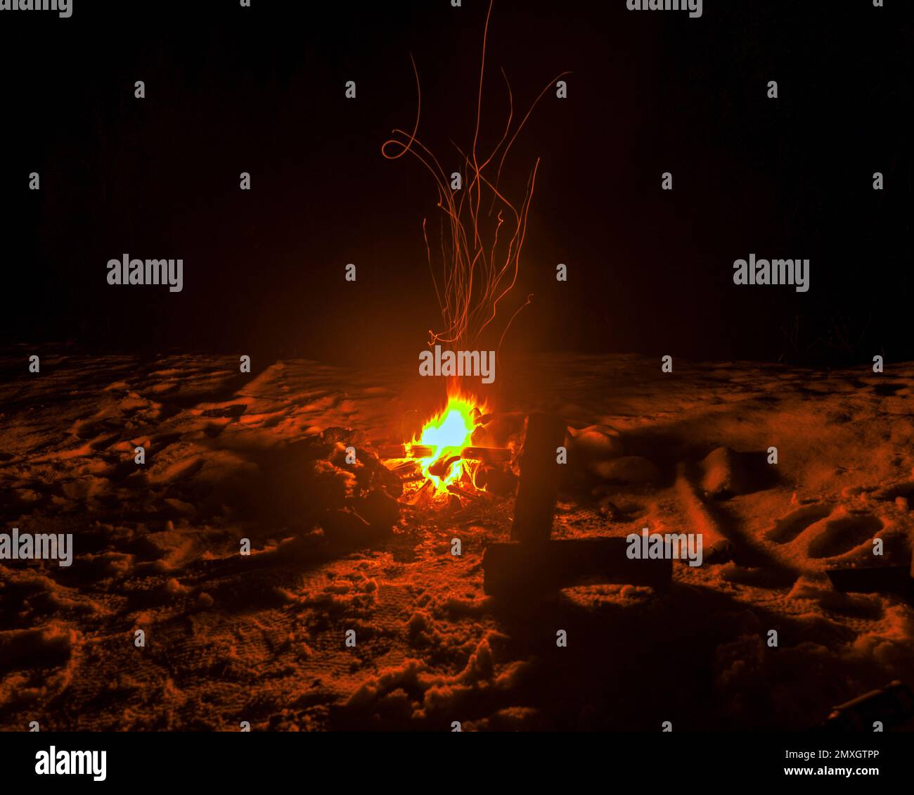 The fire burns at night in the snow Stock Photo - Alamy
