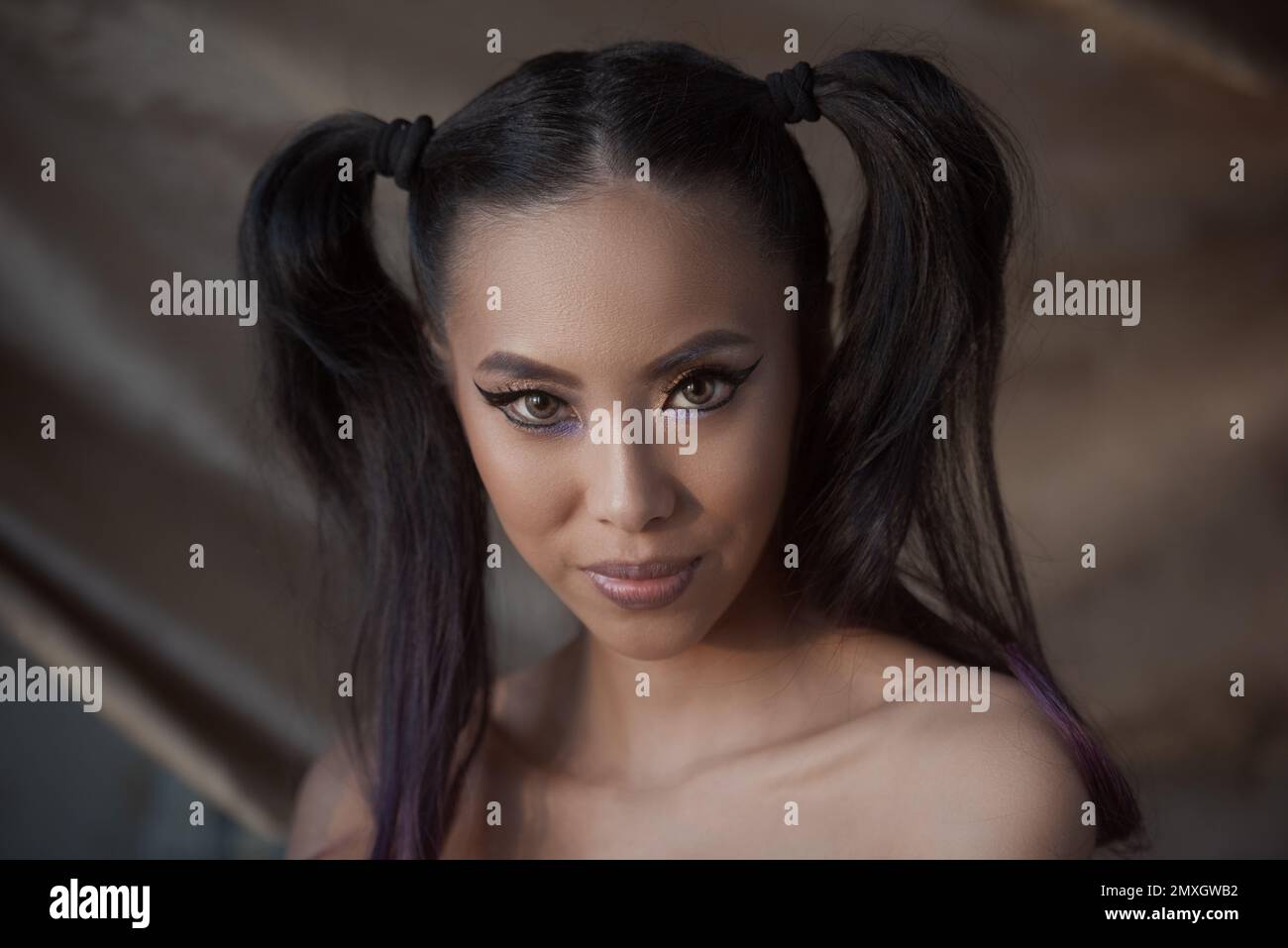 Close up portrait of young cute smiling woman with two ponytails ...