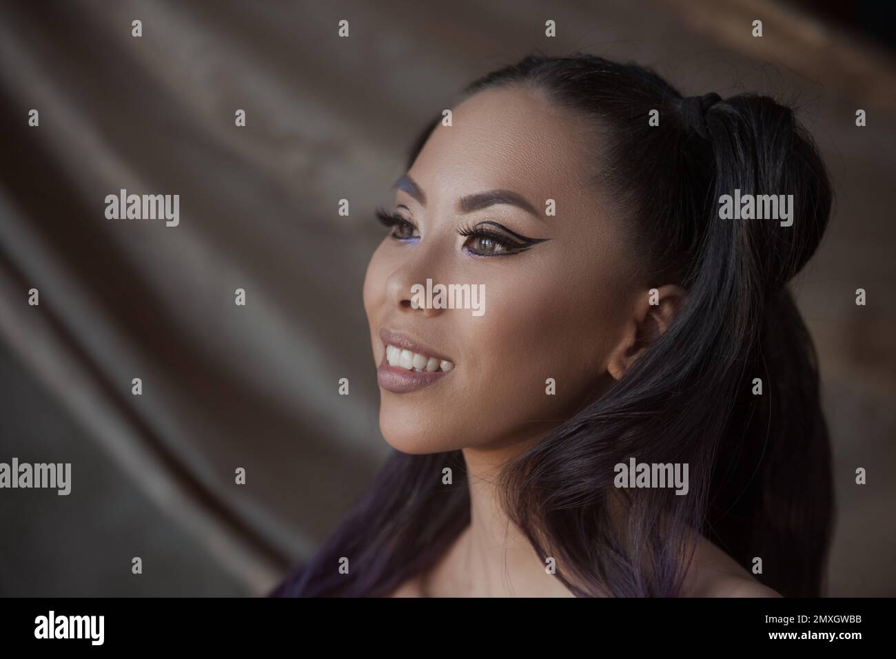 Close up portrait of young cute smiling woman with two ponytails ...