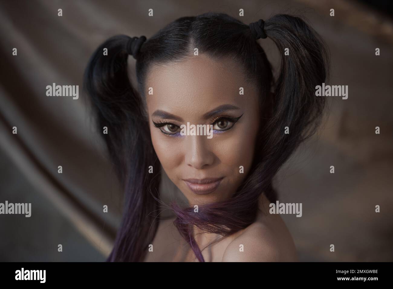 Close up portrait of young cute smiling woman with two ponytails ...
