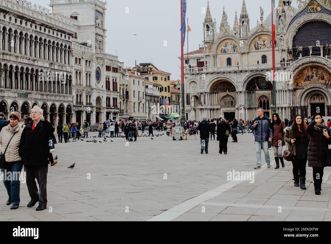 The tourists walking on Pizza San Marco on a gloomy autumn day, Venice ...
