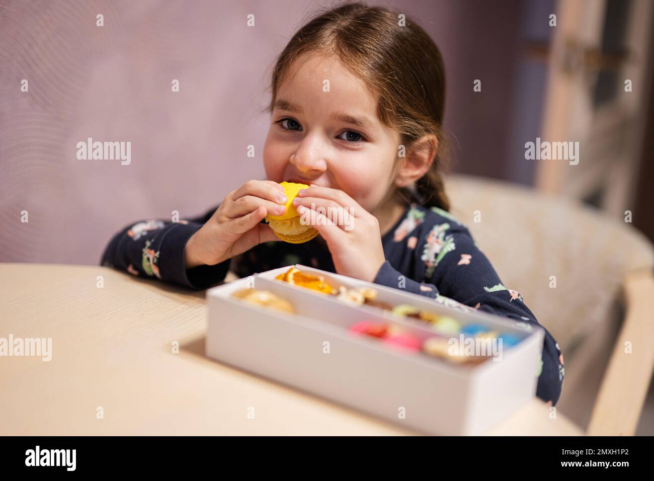 Girl eat delicious tasty sweet color macaron Stock Photo - Alamy