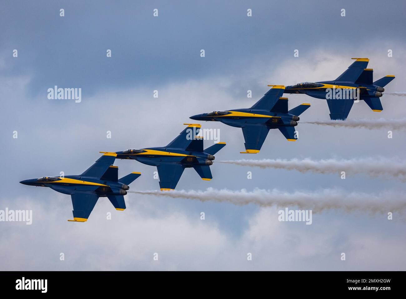 An aerial shot of the Blue Angels formation in a row performing an air ...