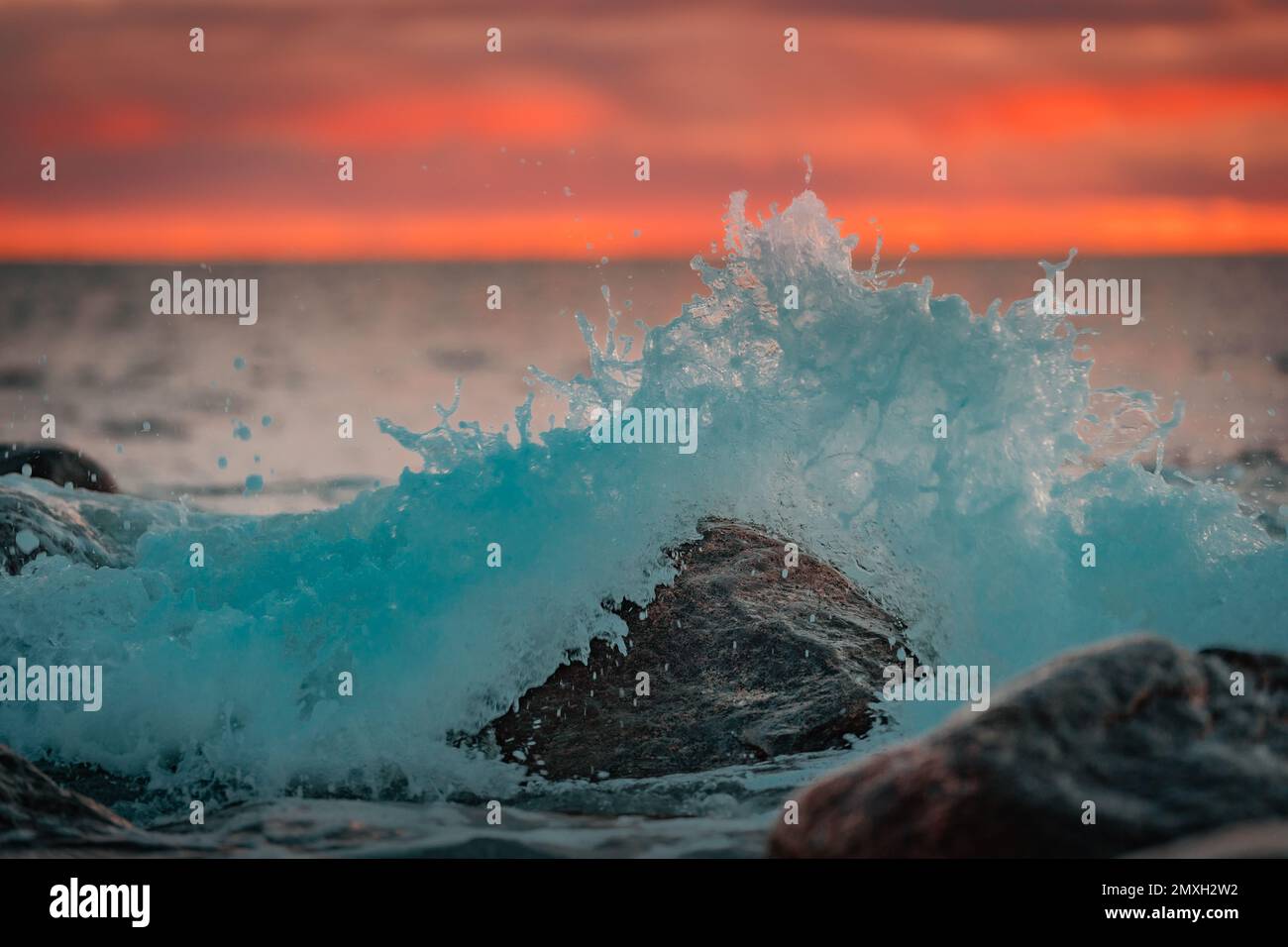 An aerial view of sea waves breaking beach during sunset Stock Photo ...