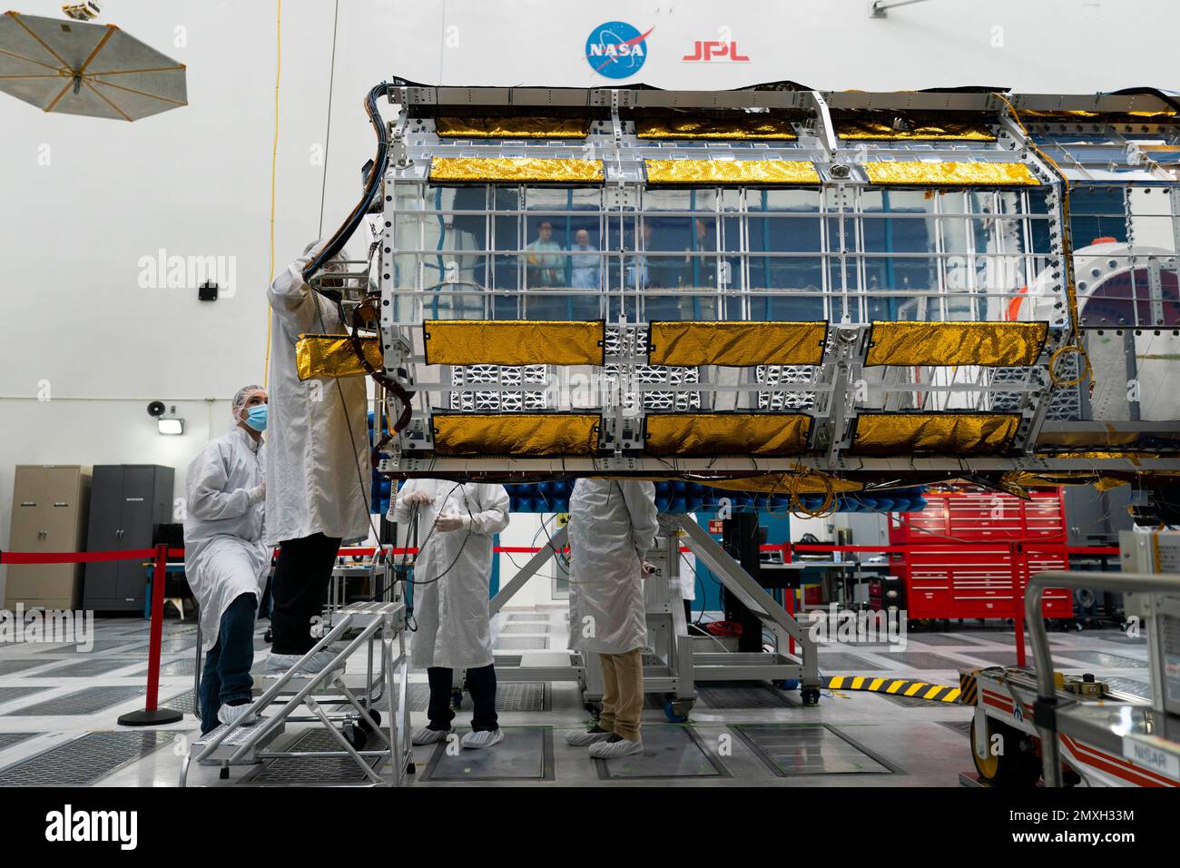 Engineers and technicians work on the scientific core of the NASA-ISRO ...
