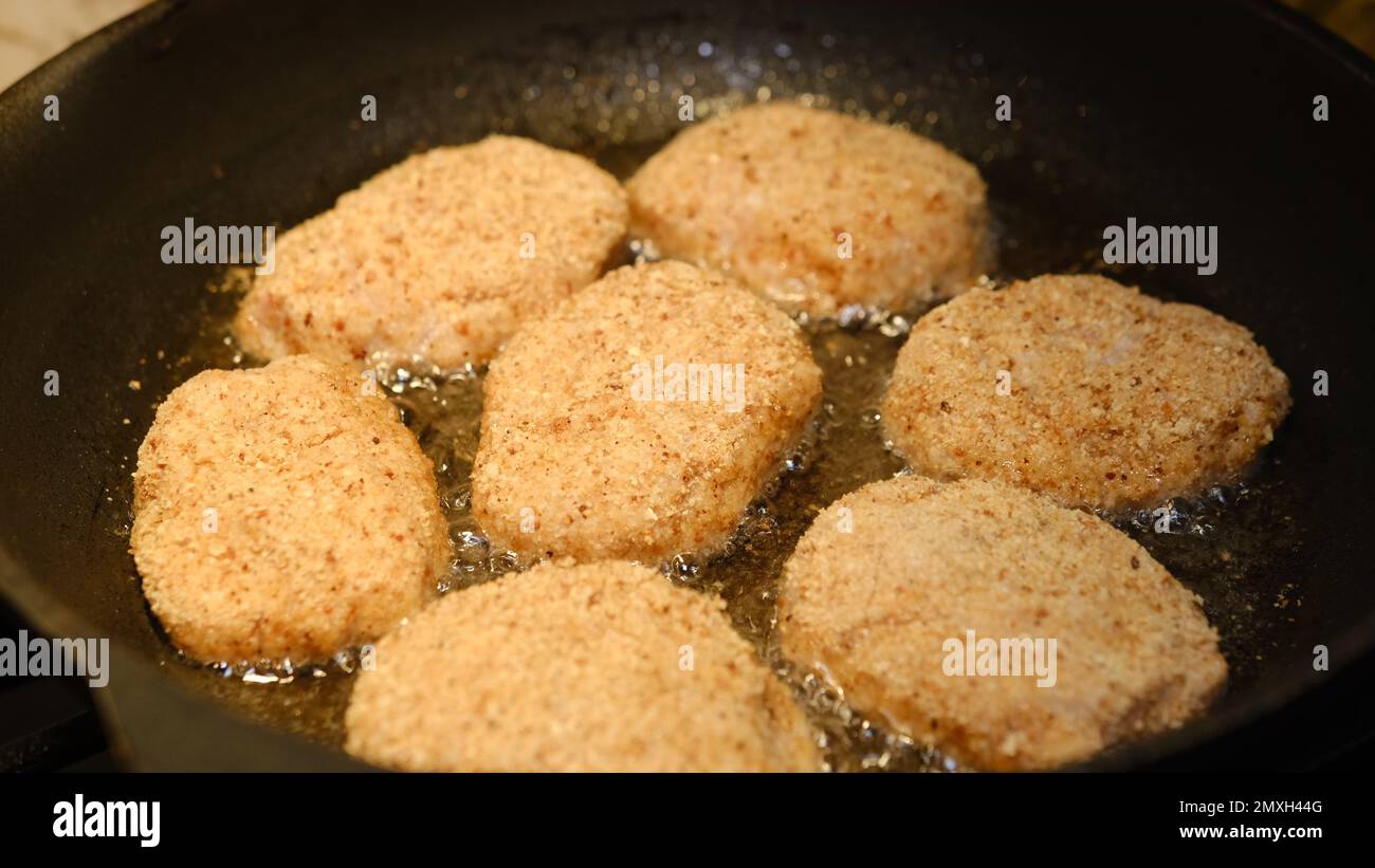 Fried cutlets in a frying pan with sunflower oil. Rustic menu ...