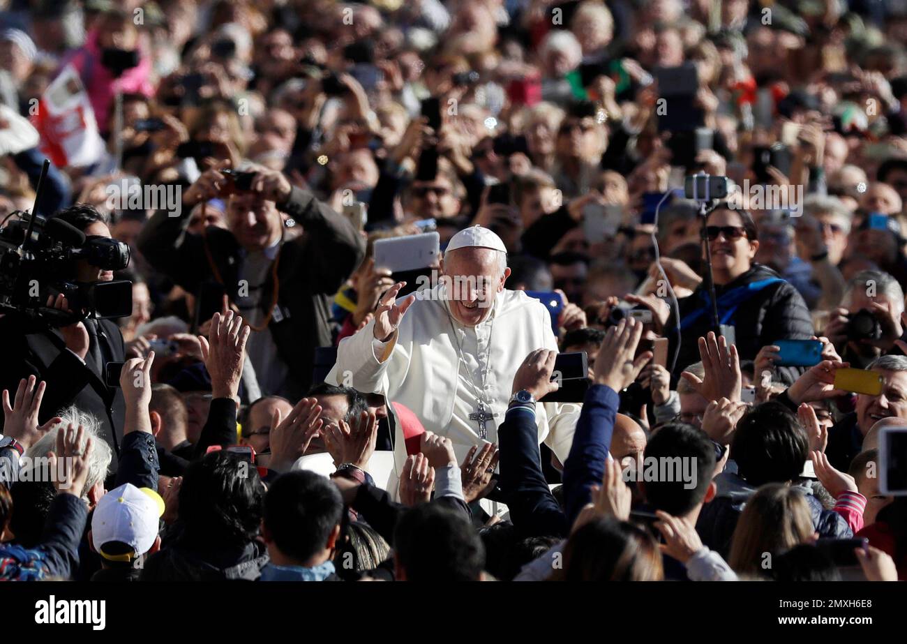 Pope Francis waves to the crowd as he arrives for a Jubilee audience in ...
