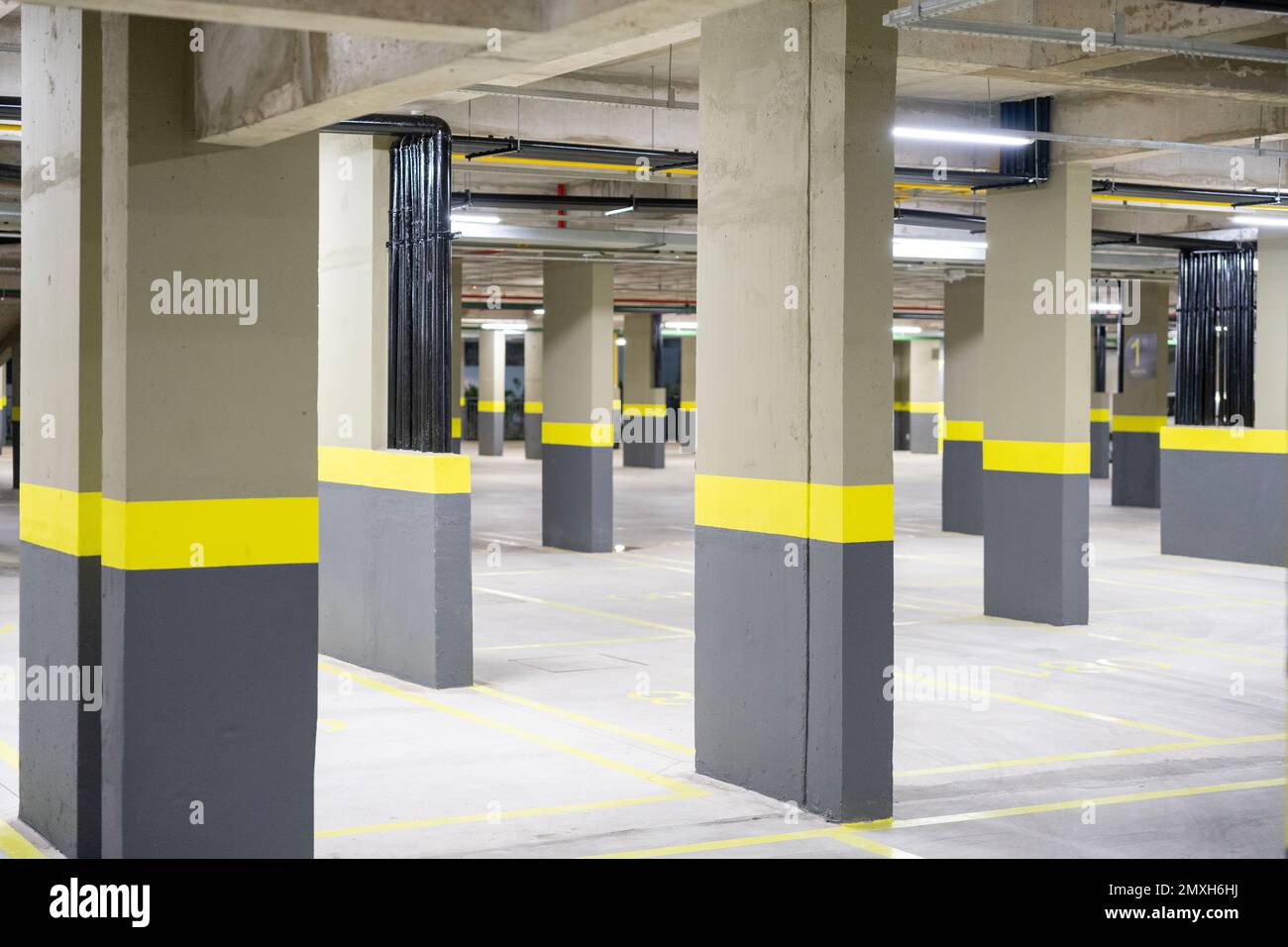 A new spacious parking lot with symmetric pillars Stock Photo - Alamy
