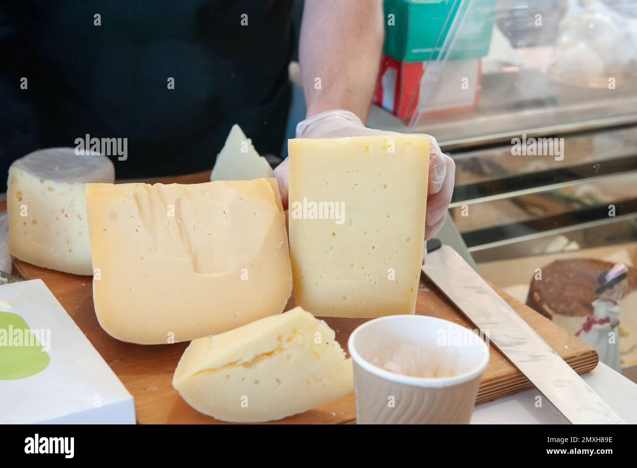 Tasting of cheese of different varieties at the farm fair. Cheese from ...