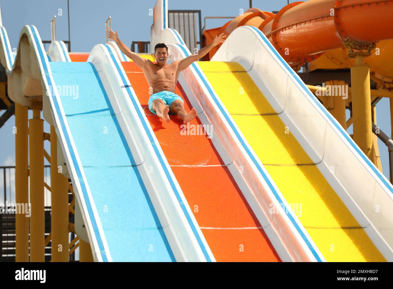 Man on slide at water park. Summer vacation Stock Photo - Alamy