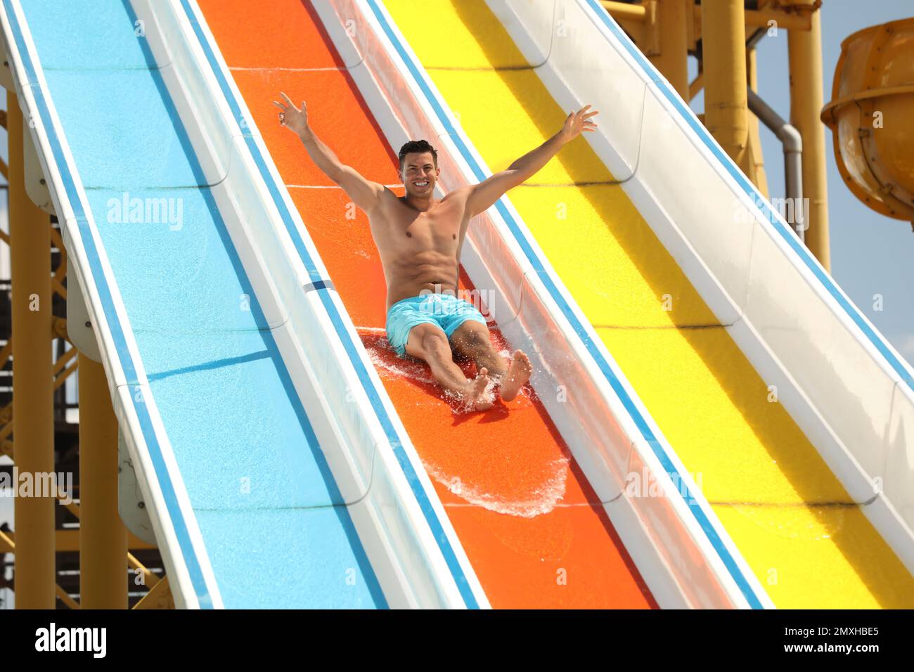 Man on slide at water park. Summer vacation Stock Photo - Alamy