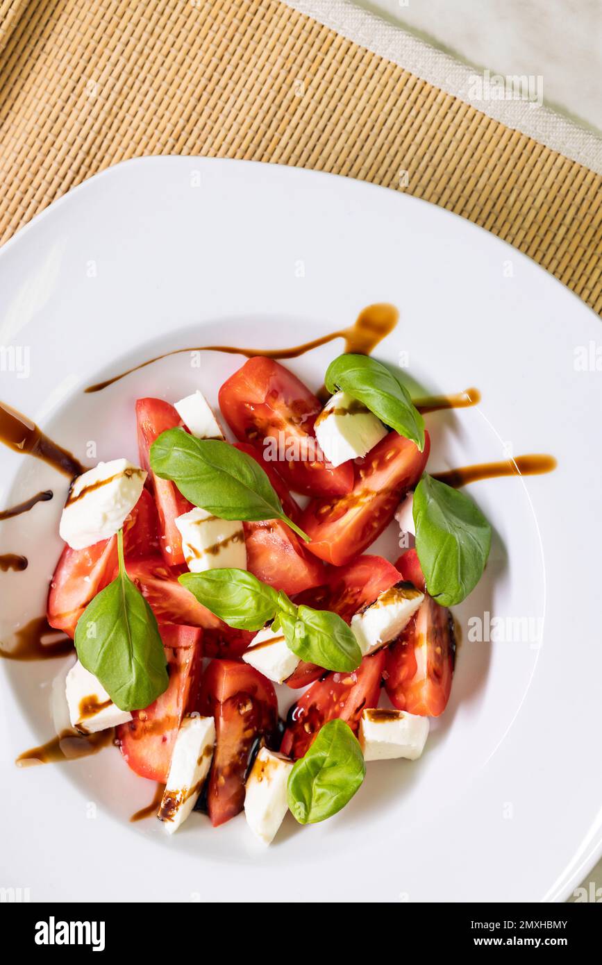 tomato salad with mozzarella, basil and balsamic cream Stock Photo - Alamy