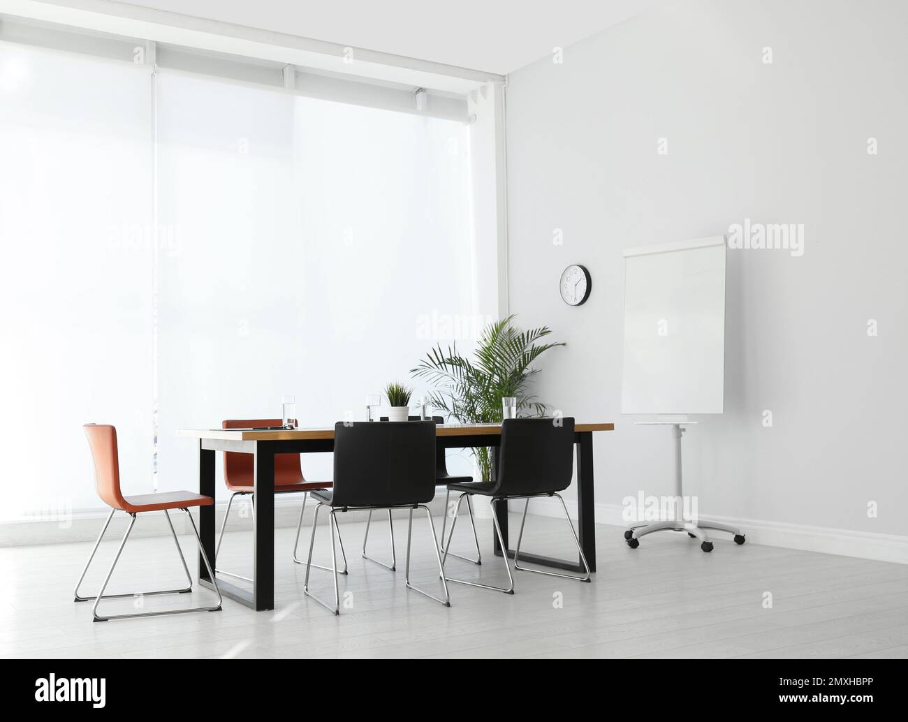 Simple office interior with large table and chairs Stock Photo - Alamy