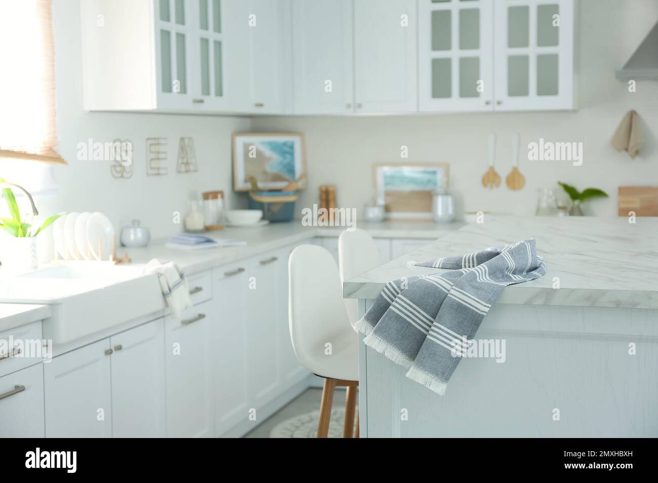 Towel on table in modern kitchen. Interior design Stock Photo - Alamy