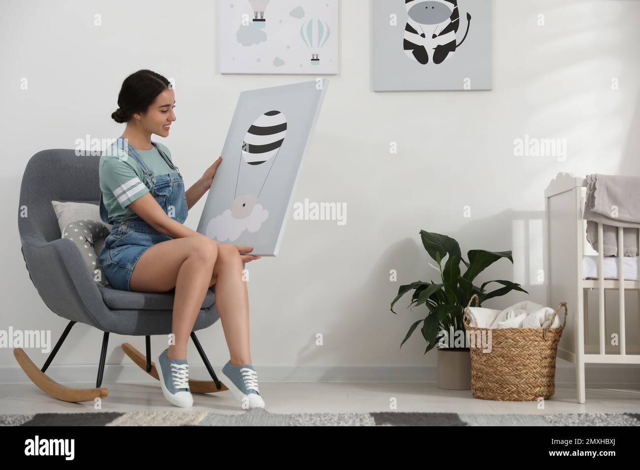 Decorator with picture sitting indoors. Children's room interior design ...