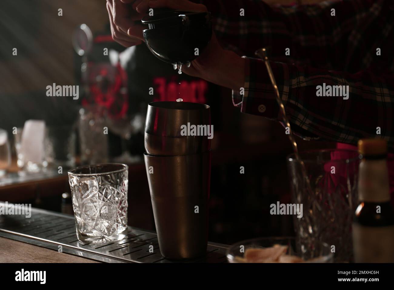 Bartender preparing fresh alcoholic cocktail at bar counter, closeup ...