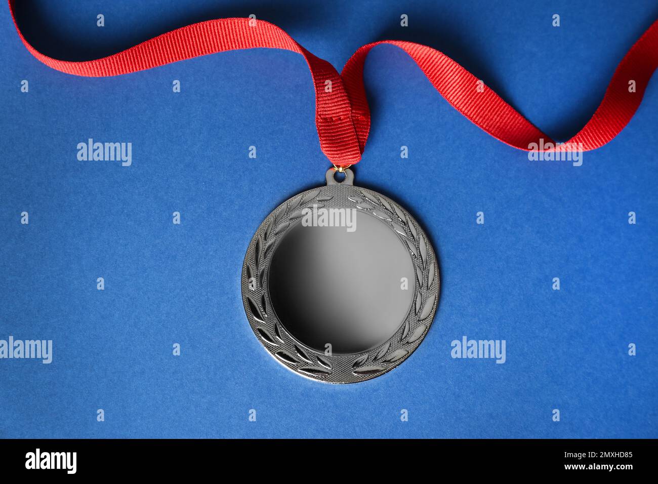 Silver medal on blue background, top view. Space for design Stock Photo ...