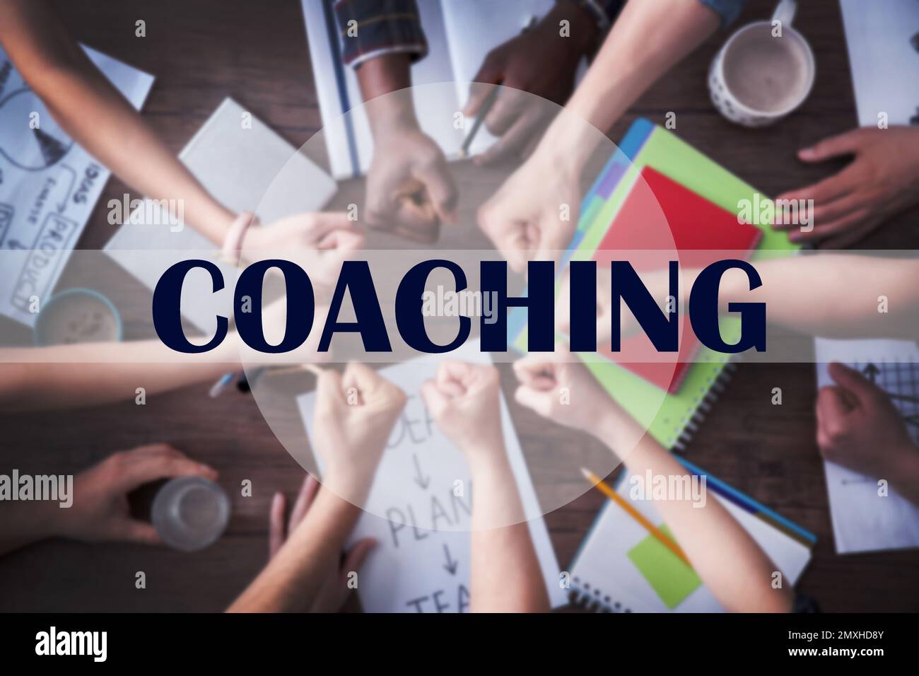 Adult learning. Word COACHING and people putting fists together at ...