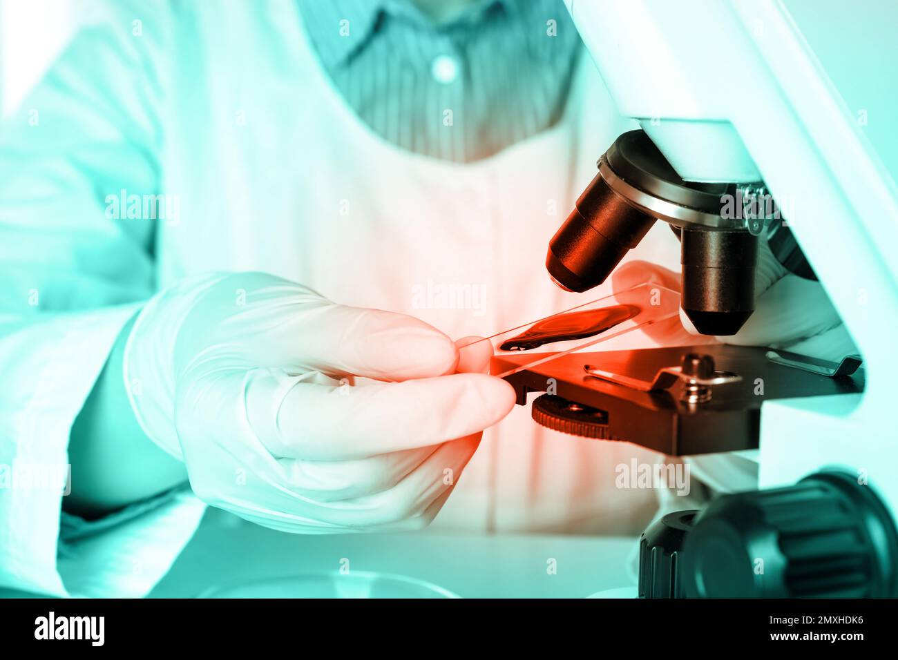 Scientist examining blood sample with microscope, closeup. Laboratory ...