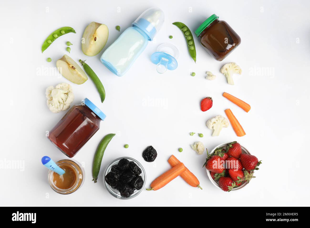 Frame of baby food, ingredients and accessories on white background ...