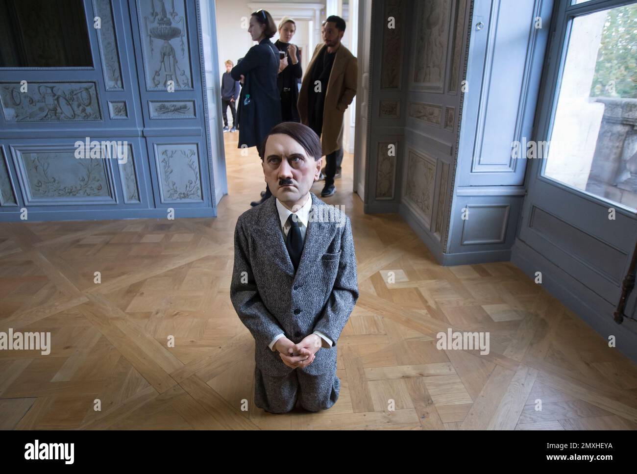 Visitors looks at "him", a controversial sculpture of Adolf Hitler, an ...
