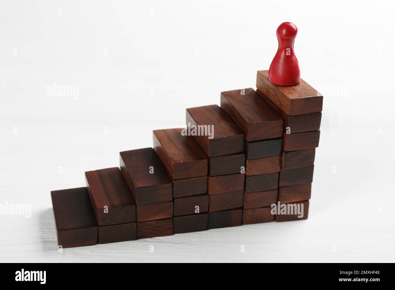 Red game piece on top of pyramid. Career promotion concept Stock Photo ...
