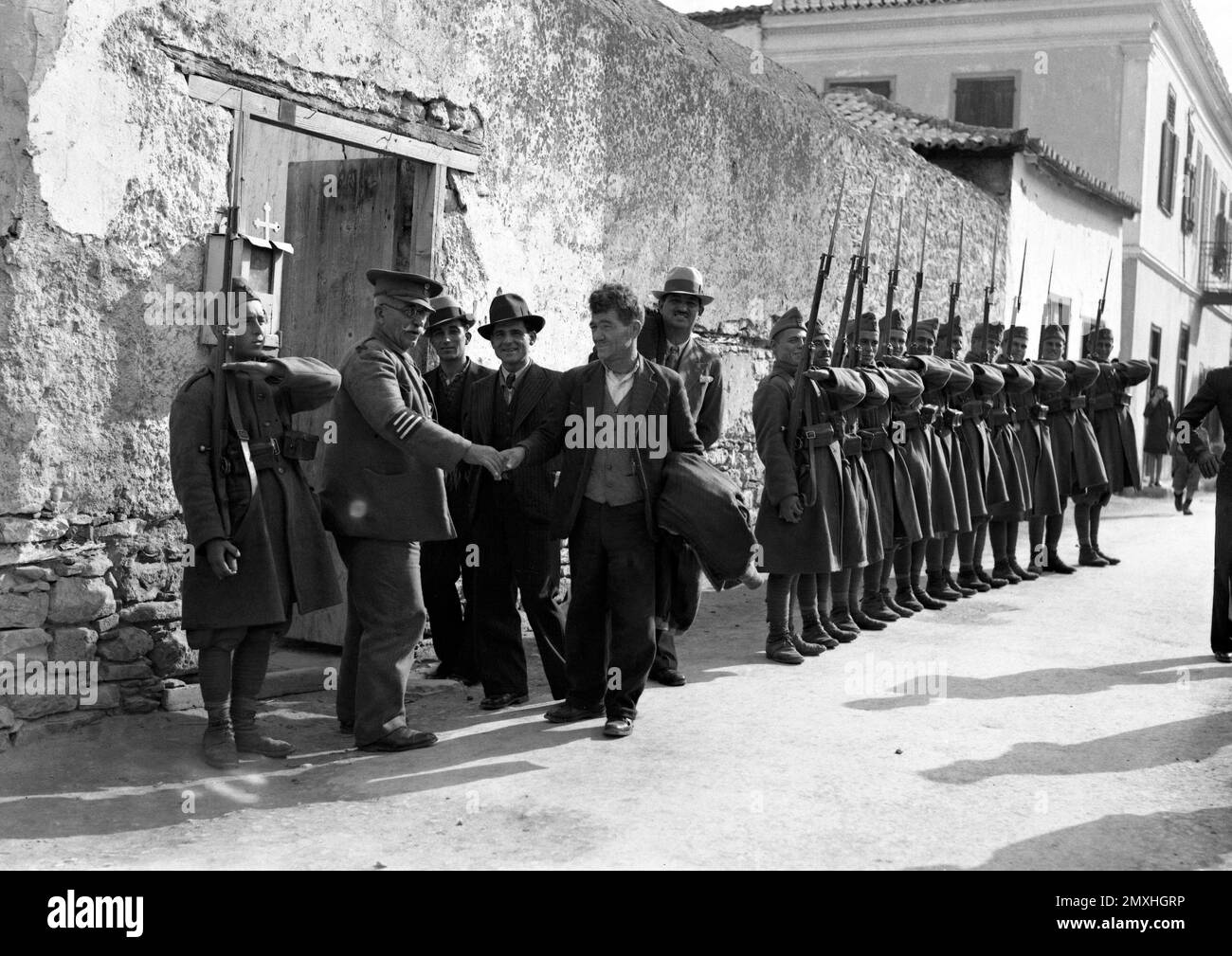 At the prison gates in Athens, soldiers raised their rifles in salute ...