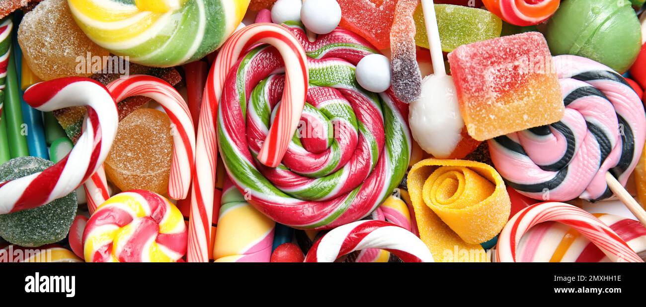 Many different yummy candies as background, top view. Banner design ...