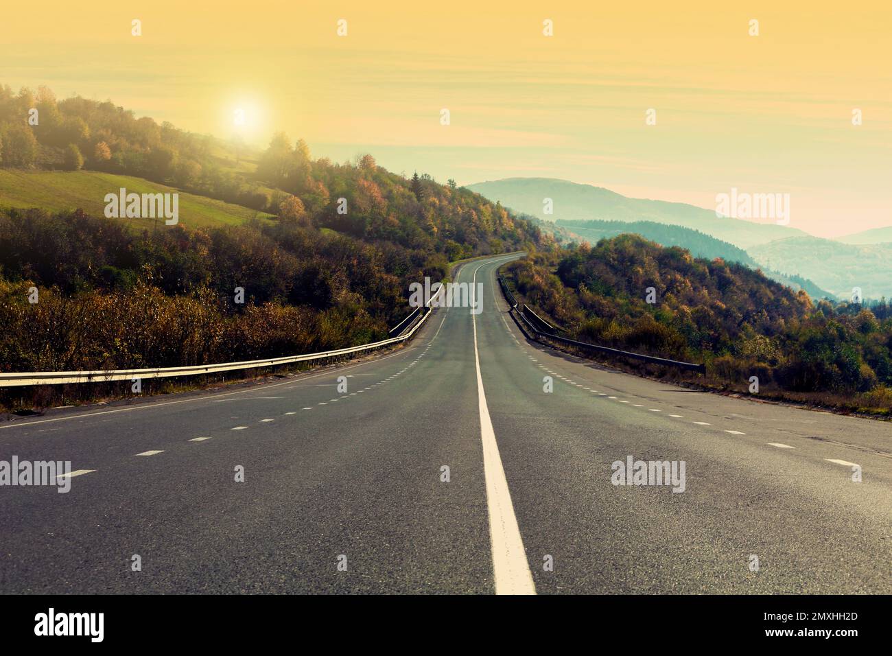 Road trip. Beautiful view of asphalt highway at sunset Stock Photo - Alamy