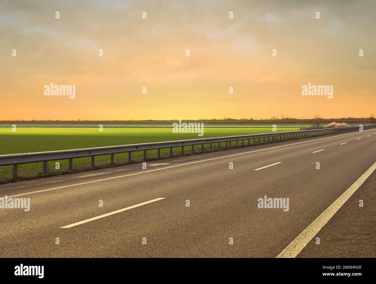 Road trip. Beautiful view of asphalt highway at sunset Stock Photo - Alamy