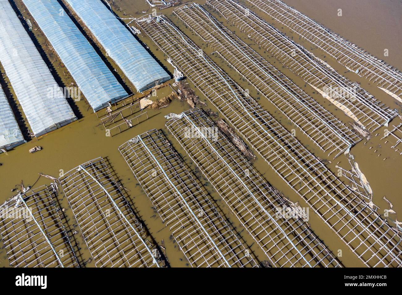 Aerial view of a farm flooded during the spring flood, greenhouses in ...