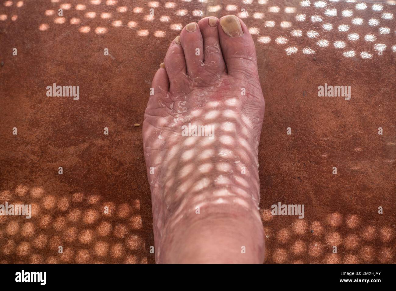 Light patterns reflected on foot, Playa Blanca, Canary Islands, Spain ...